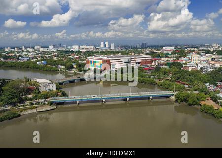Aerial view of the Iloilo River reflecting the sky, while the vibrant ...