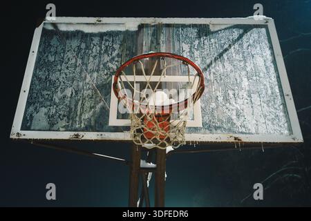 Night scene of basketball hoop during winter with snow, town of Cacak ...