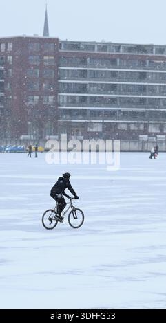 A man rides a bike in the frozen Finnish Gulf outside St. Petersburg ...