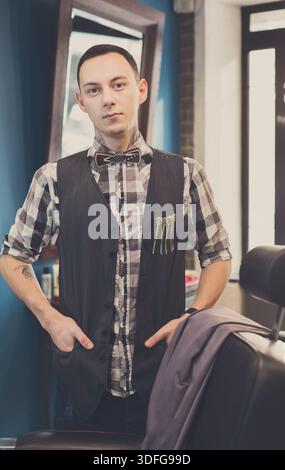 Barber invites to have seat on chair at barbershop Stock Photo - Alamy