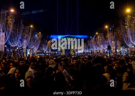 Paris, France - January 1, 2026: The crowd gathered on the Champs ...