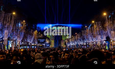 Paris, France - January 1, 2026: The crowd gathered on the Champs ...