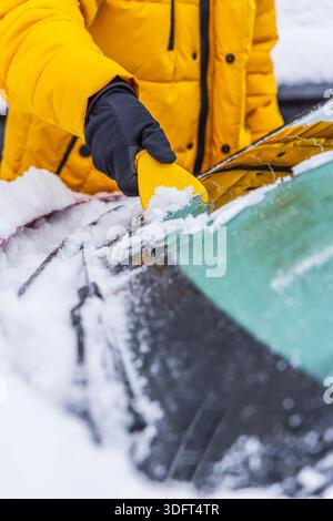 removing snow and ice from the car Stock Photo - Alamy