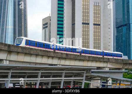 High-speed, driverless metro train travels across a city skyline on a ...