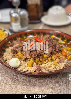 Traditional Uzbek oriental cuisine table with yellow melon date, dry ...