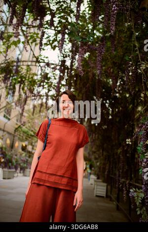 Smiling Young Woman Hanging Greenery On Wall At Home, Bright Lifestyle ...