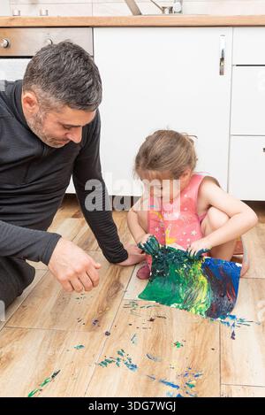 Father and child drawing together with colorful markers, sharing a ...