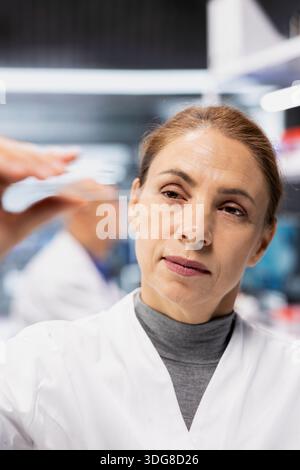 Microscope slide preparation. Close-up of a student preparing an onion ...