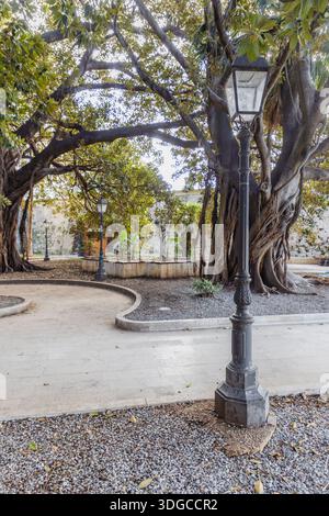 Sidewalk and light post beside stone towers on the large wall of Avila ...