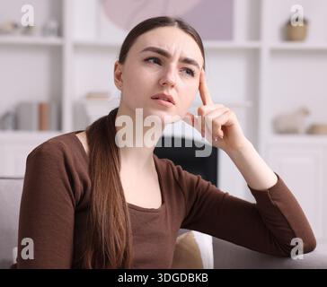 Amnesia concept. Woman trying to remember something. Question marks on ...