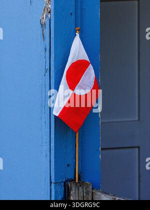 A circular door in red, blue, and yellow stands in front of a stone ...
