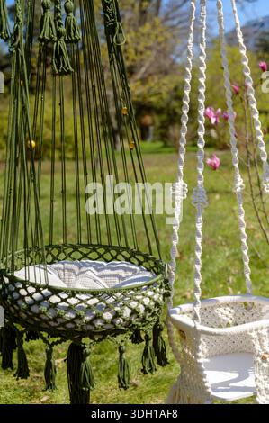 Rope cradle swing hanging on wood on the beach with wooden boat in ...