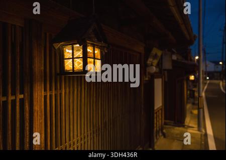 Japan in evening with illuminated hanging lantern lamp light on wooden ...