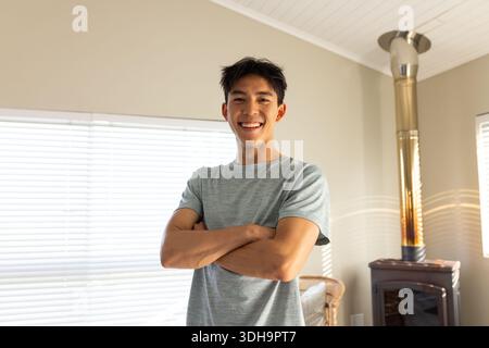 Standing man wearing beige-tee teal-shorts holding padel racket at blue ...