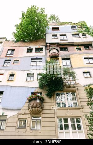 People walk past a residential building destroyed after a Russian ...