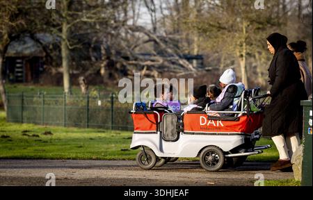 THE HAGUE - Childcare workers walk with children on the street ROBIN ...