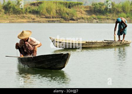 Local fishermen in small wooden boat on foreground with offshore supply ...