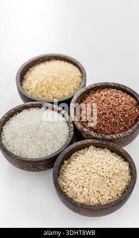Different kinds of rice in bowls on table on sackcloth background Stock ...
