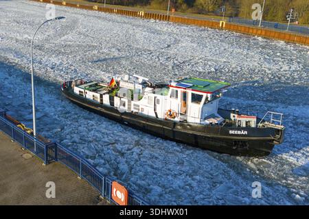 A boat navigates through the ice-covered Moskva River during heavy ...