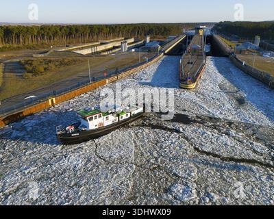 A boat navigates through the ice-covered Moskva River during heavy ...