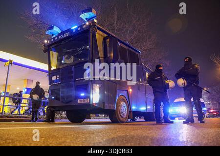 26 January 2026, Hamburg: A water police boat navigates through ice ...