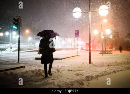 Laatzen, Germany. 26th Jan, 2026. A man walks to a light rail station ...