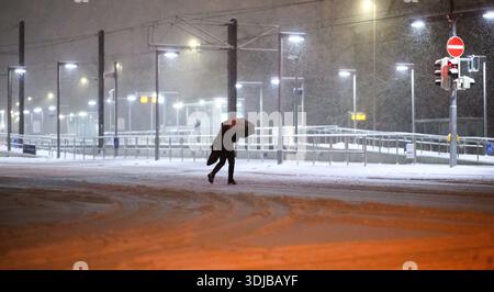 Laatzen, Germany. 26th Jan, 2026. A man walks to a light rail station ...