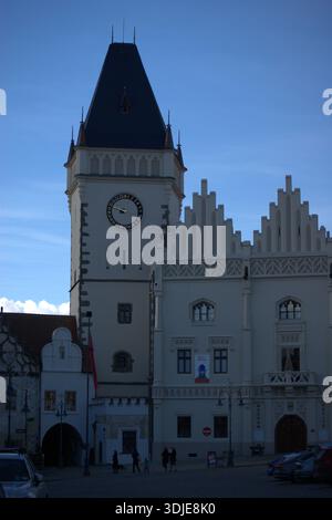 Historic white castle tower with a conical roof surrounded by green ...
