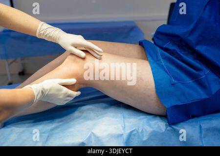 Leg vein assessment by doctor using visual inspection and palpation ...