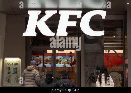 Pedestrians pass a KFC store on the Nanjing Road Walkway in Shanghai ...