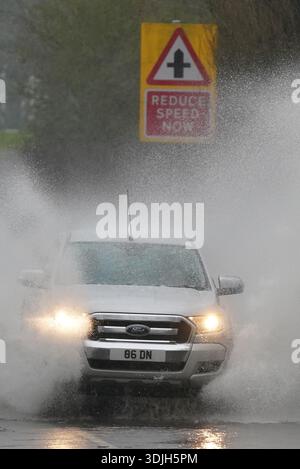 A vehicle driving through the pooled rainwater on the A20 in Ashford ...
