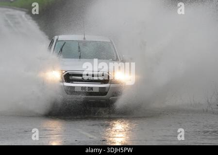 A vehicle driving through the pooled rainwater on the A20 in Ashford ...