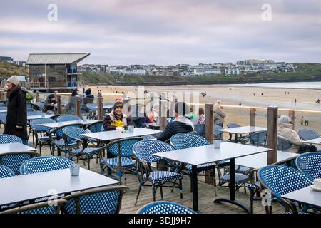 People sitting on the outdoor decking area of the Fistral Boardmasters ...