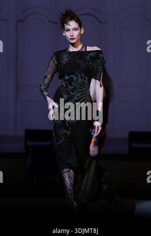 A model walks the runway during the Julien Fournié Haute Couture Week ...