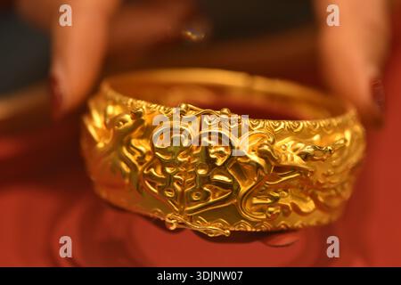Gold jewelry being photographed in a gold shop in Fuyang City, Anhui ...