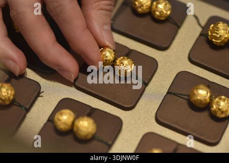 Gold jewelry being photographed in a gold shop in Fuyang City, Anhui ...