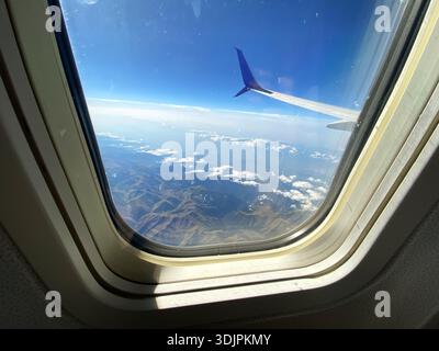 View from airplane window featuring aircraft wing taxiing on tarmac ...