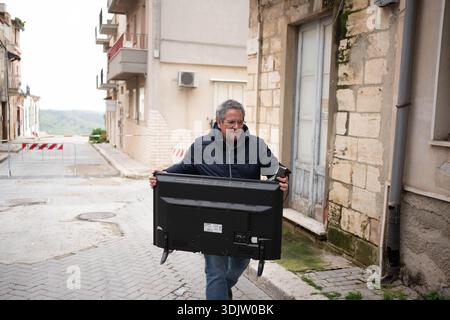Residents of Niscemi collect personal items during the evacuation of ...