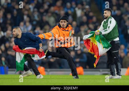 Palestinian fan runs into the pitch during the UEFA Champions League ...