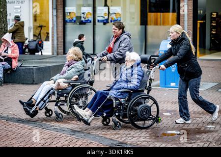 GOUDA - Walking on the street with a person in a wheelchair ROBIN ...