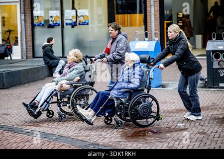 GOUDA - Walking on the street with a person in a wheelchair ROBIN ...