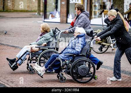 GOUDA - Walking on the street with a person in a wheelchair ROBIN ...