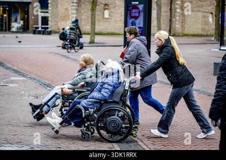 GOUDA - Walking on the street with a person in a wheelchair ROBIN ...
