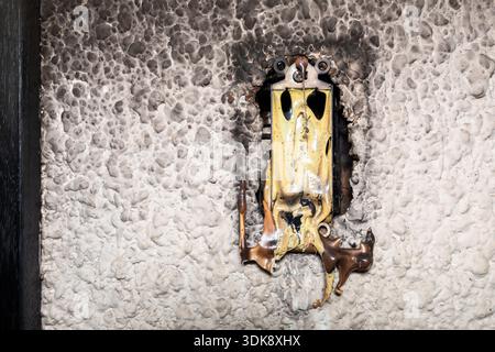 Melted light switch with fire damage, close up. Light regulator mounted ...