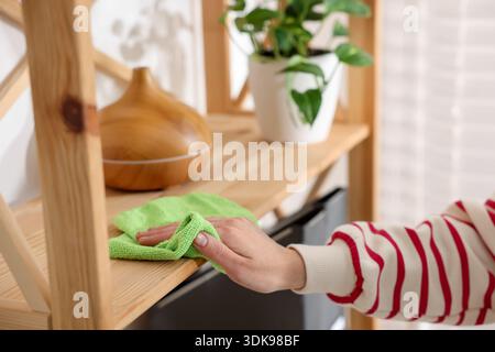 Woman wiping wooden shelf with microfiber cloth at home, closeup Stock ...