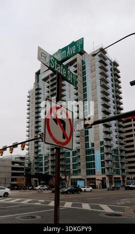 Pedestrian crossing sign on quiet green city street in urban spring ...