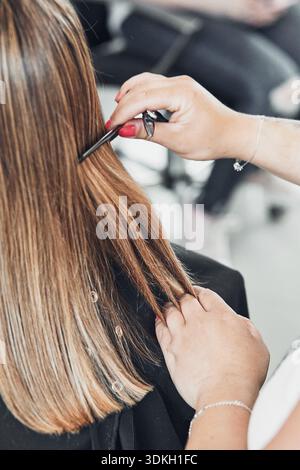 young authentic woman styling her hair with a curly method Stock Photo ...