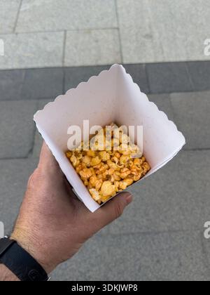 Holding a cup of corn at a street food stand Stock Photo - Alamy
