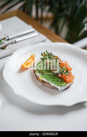 Healthy avocado toast with cream cheese on rye bread. A fresh ...