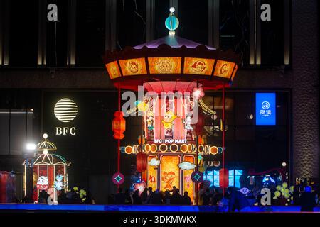 The Pop Mart carnival carousel horse ride is illuminated in front of ...